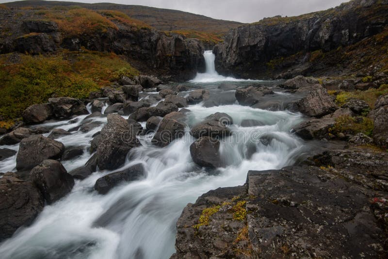 Waterfall Cascading Over a Backdrop of Rocky Terrain. Stock Photo ...