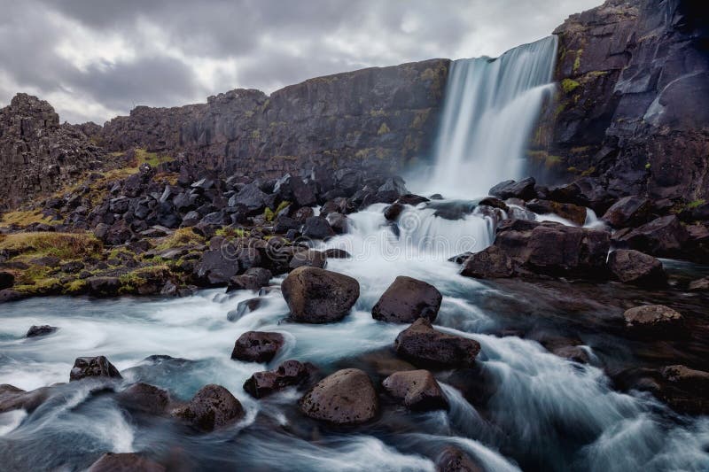 Waterfall Cascading Over Rocks in Dramatic Landscape, Iceland Stock ...