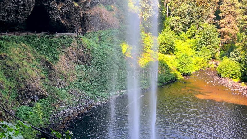 Waterfall Cascading Over Rocks in a Lush Forest. a Majestic Waterfall ...