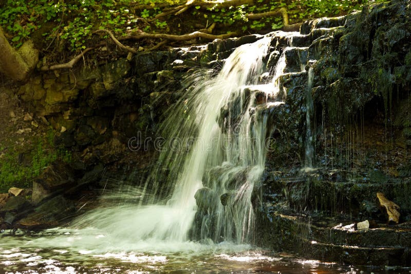 Waterfall in countryside stock image. Image of vegetation - 19911969