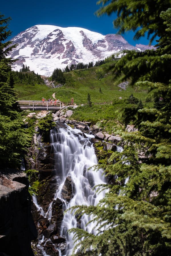 Waterfall Crashes Down in Front of the Snow Capped Mount Rainier Stock ...