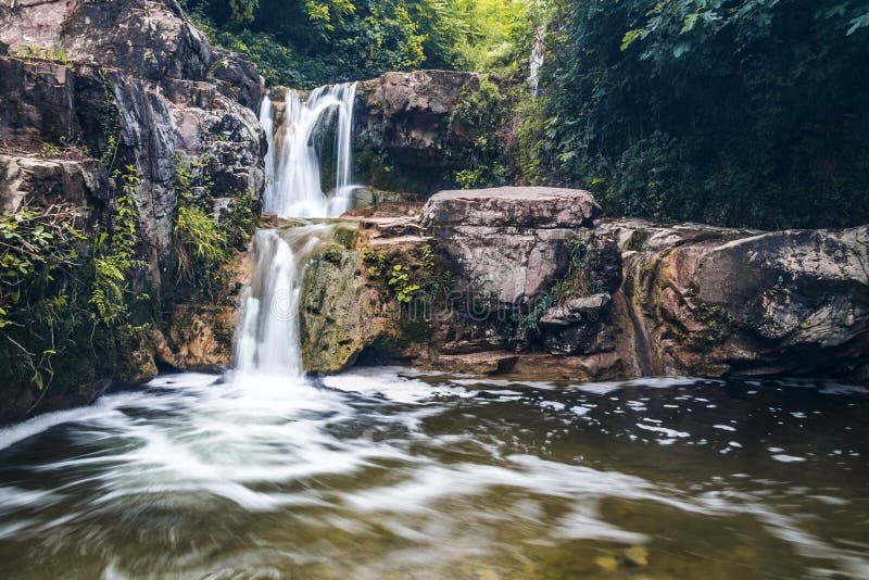 Waterfall in deep forest stock photo. Image of jungle - 57420872