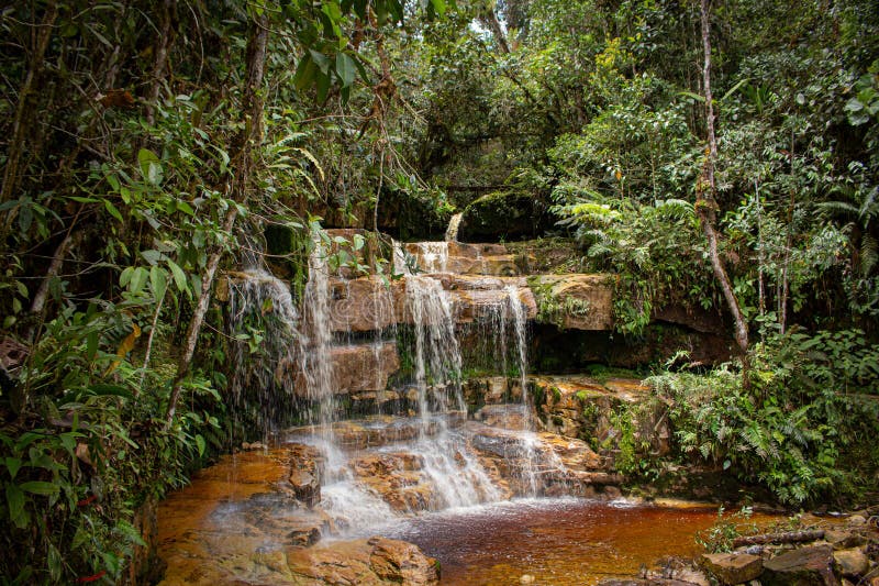 Waterfall that Ends in an Orange-colored Pool Located Deep in the ...