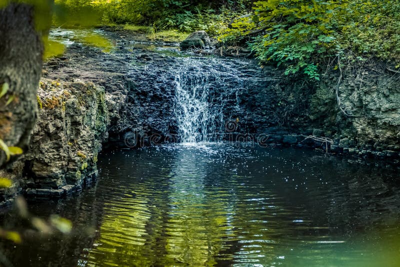 Waterfall Falling Down from a Rock Cascade. Stock Photo - Image of park ...