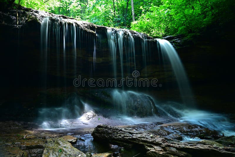 Waterfall Falling from Rocks Surrounded by Green Trees Stock Photo ...