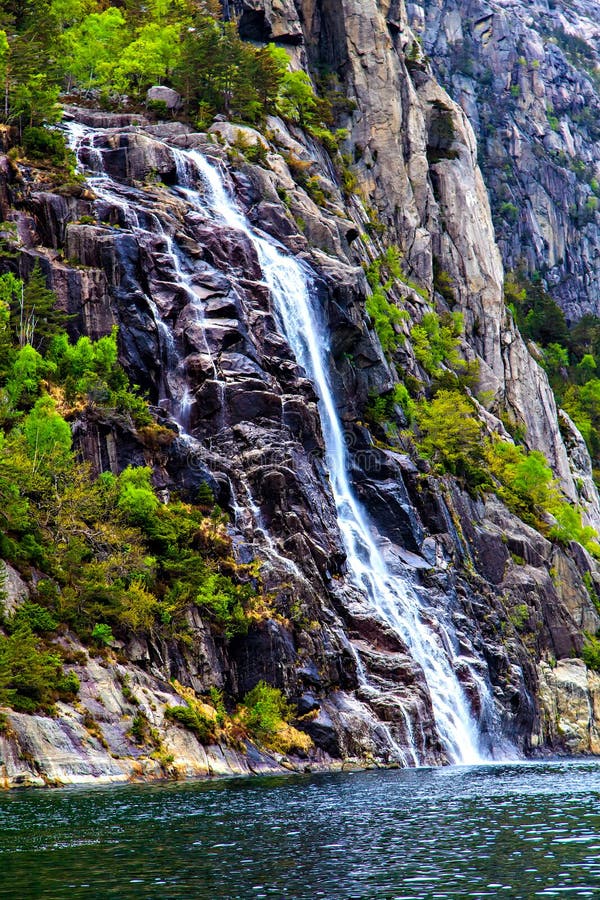 Waterfall Flowing Down the Cliff into the Sea Stock Photo - Image of ...