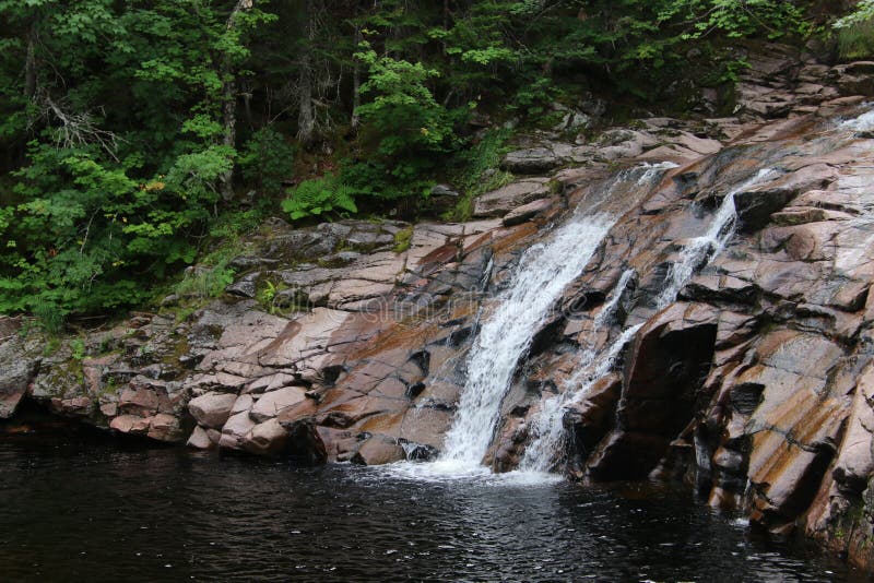 A Waterfall Flowing Down a Short Cliff Stock Image - Image of landscape ...