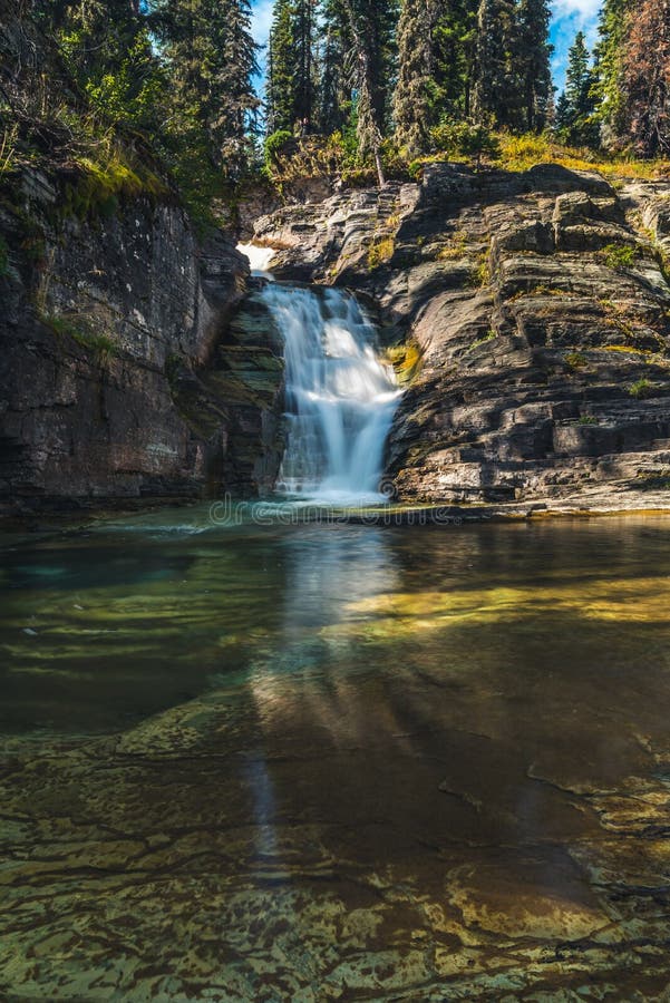 Waterfall Flowing into a Pond. [Portrait] Stock Image - Image of lush ...