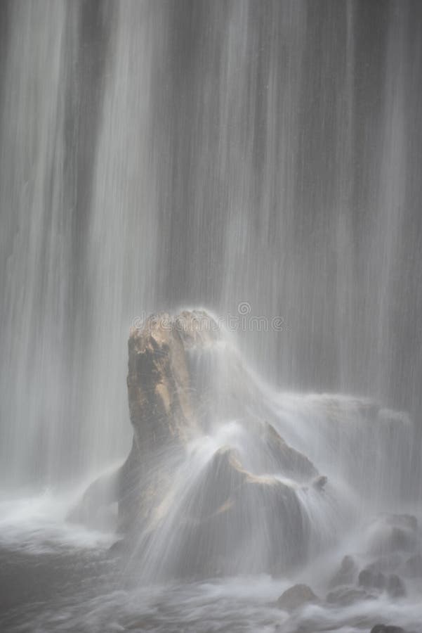 Waterfall Flowing on a Tree Stump in a Cave Stock Photo - Image of ...