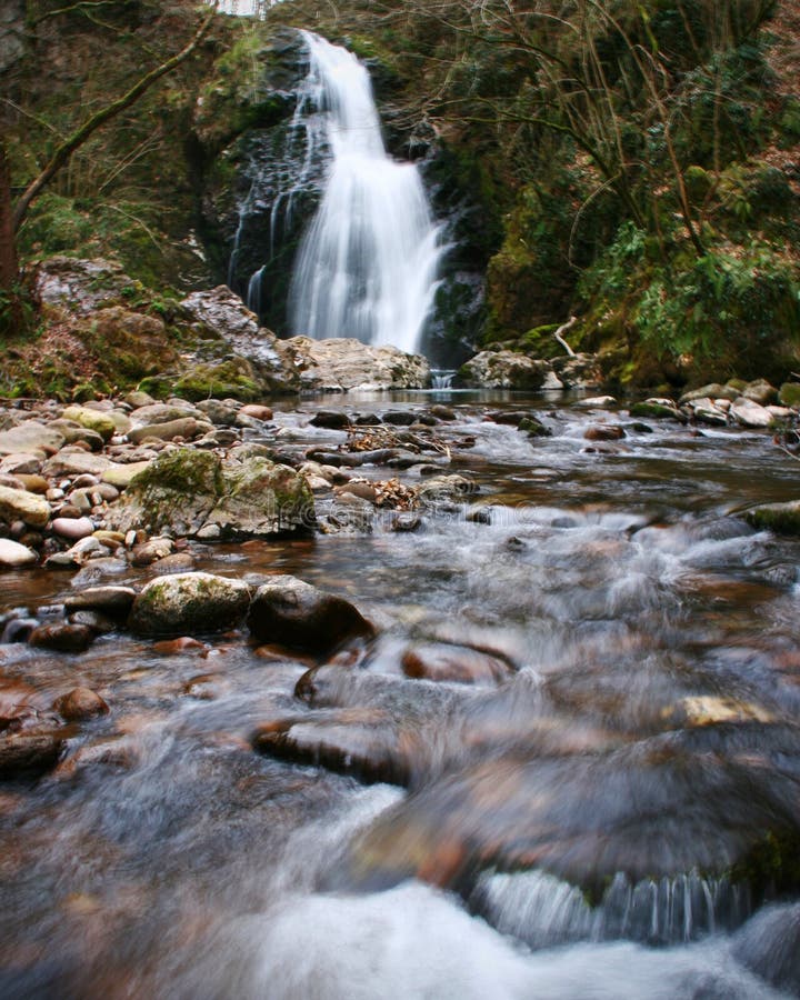 Waterfall with Flowing Water Over Rocks in a Forest Stock Photo - Image ...