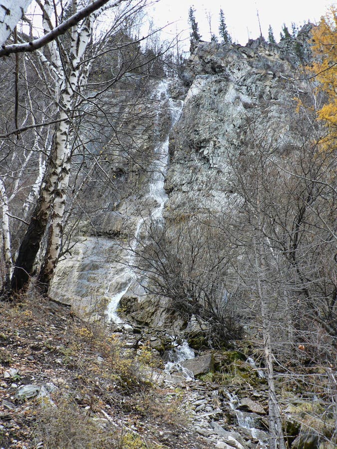 Waterfall Flows Down from the Cliff. Trees on Each Side Stock Photo ...
