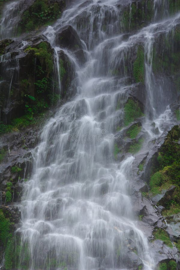 Waterfall Flows Down the Long Line of Cliffs Stock Photo - Image of ...