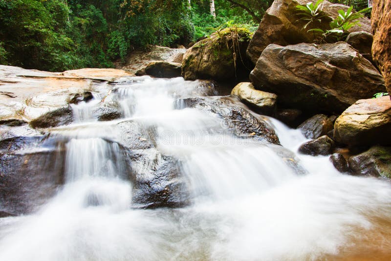 A waterfall in the forrest stock image. Image of green - 67345751