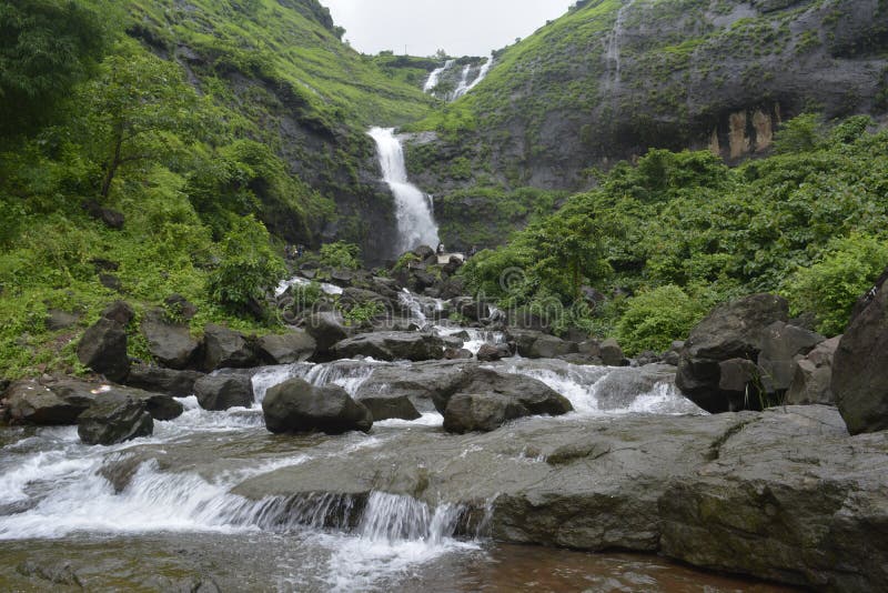 Waterfall Going Down the Rocks Surrounded by Trees and Sunlight Stock ...