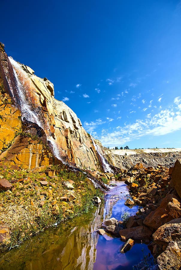 Waterfall in a Granite Quarry, Landscape with Red Stones and Blue Sky ...