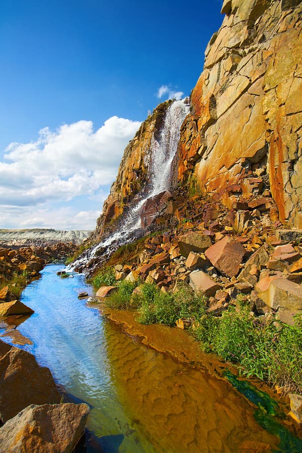 Waterfall in a Granite Quarry, Landscape with Red Stones and Blue Sky ...