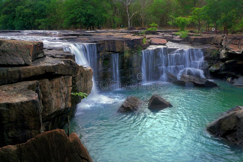 Waterfall in green forest stock image. Image of water - 317972621