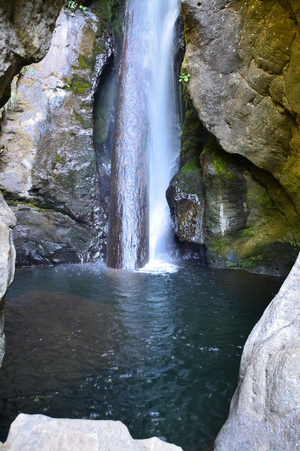 WATERFALL CAVE and LOG stock image. Image of inside - 111744891