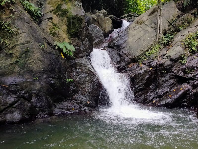 Waterfall that Has Large Rocks As a Cliff Next To the Waterfall Stock ...