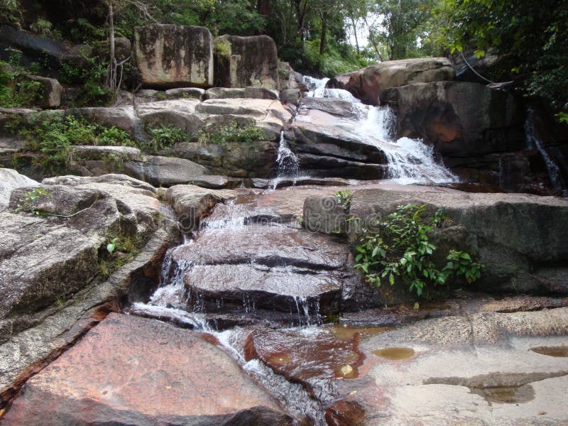 Massive Stone Slabs by Flowing Water of Waterfall Over it. Stock Photo ...