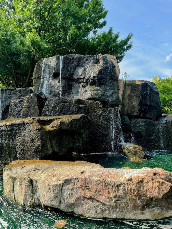 Waterfall with Large Rocks and Blue Water Running and Flowing Stock ...