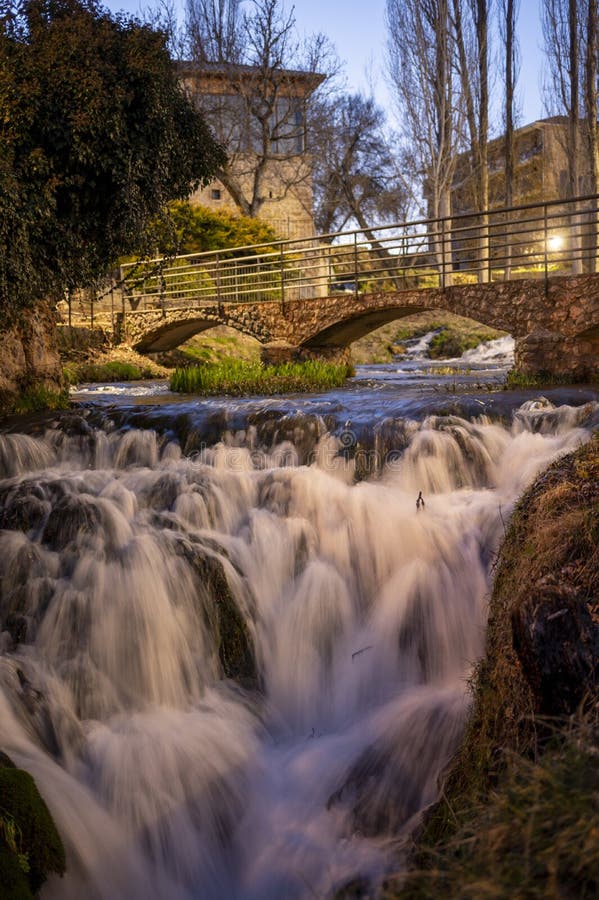 A Waterfall Lit Up at Night Running through a Town Stock Photo - Image ...
