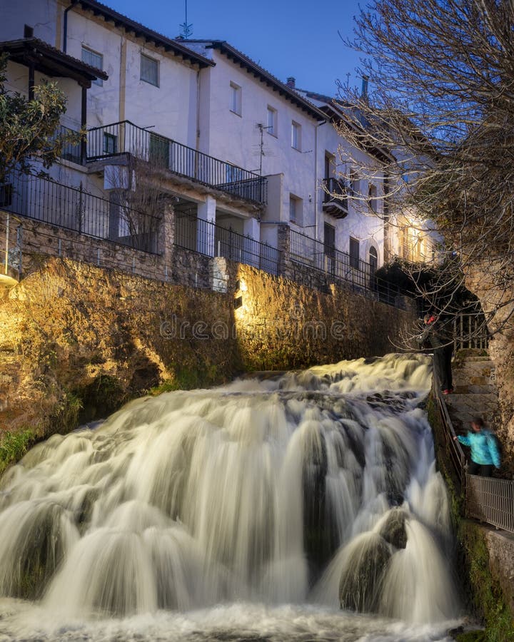 A Waterfall Lit Up at Night Running through a Town Stock Photo - Image ...