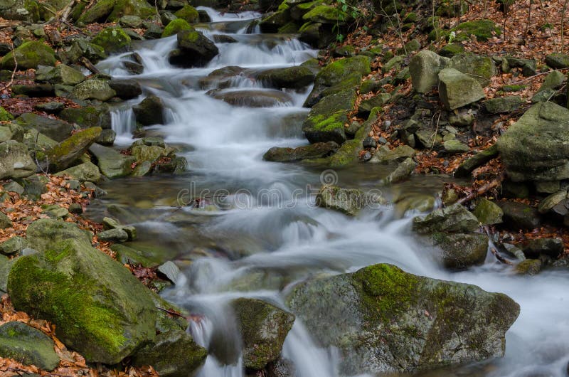 Waterfall with mossy rocks stock photo. Image of motion - 52728000