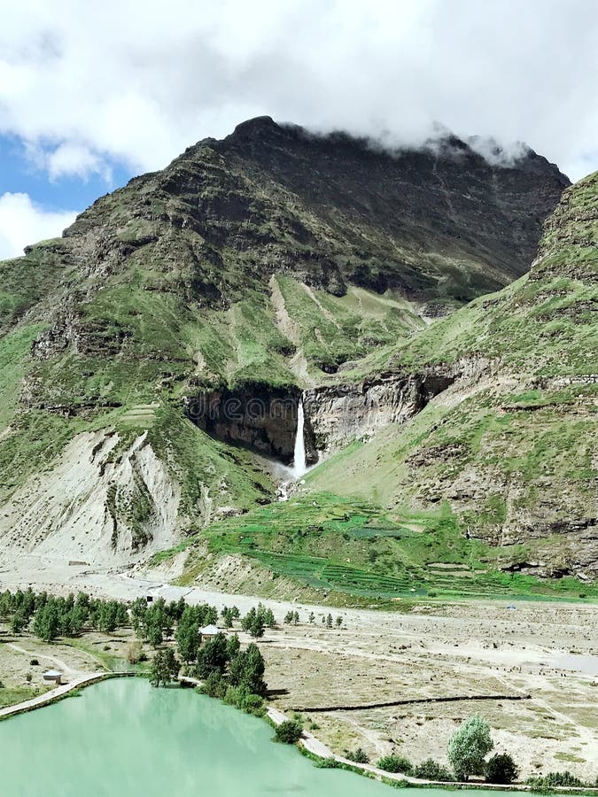 Waterfall between Mountains with Clouds and Lake Stock Image - Image of ...