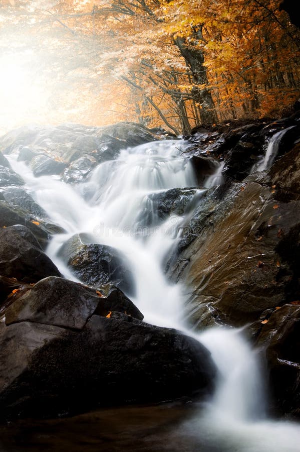 Waterfall on Mountain River with Colorful Trees in Background Stock ...