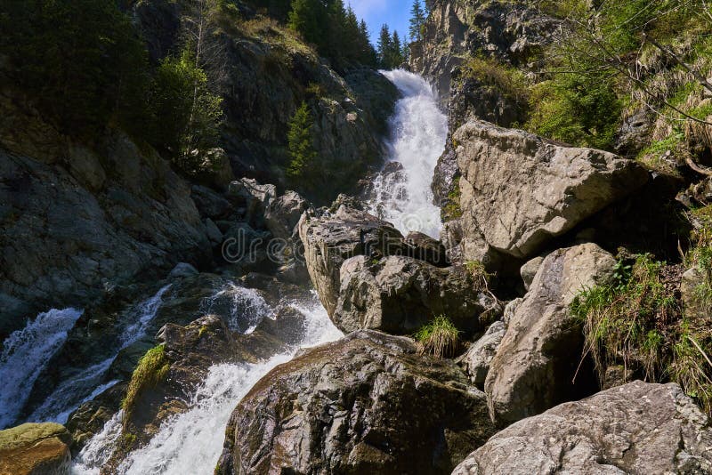 Waterfall in the mountains stock photo. Image of forest - 149197396
