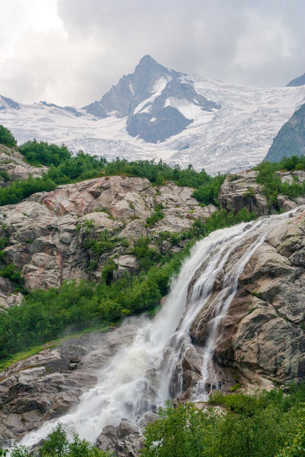 Waterfall in the mountains stock photo. Image of landscape - 268437600