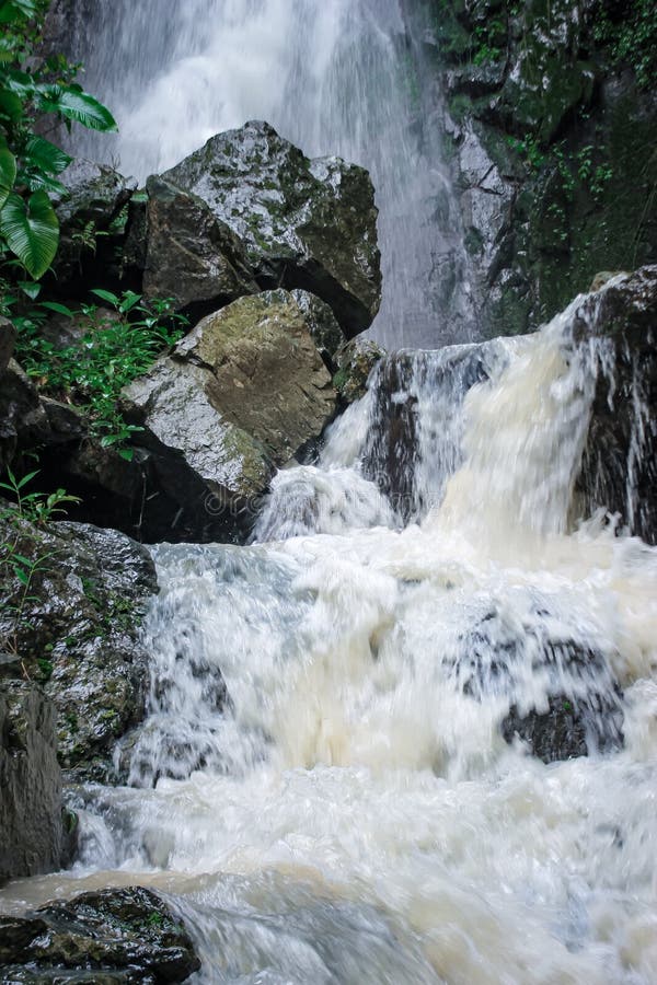 A Waterfall that Passes through the Rocks in the Interior of the Forest ...