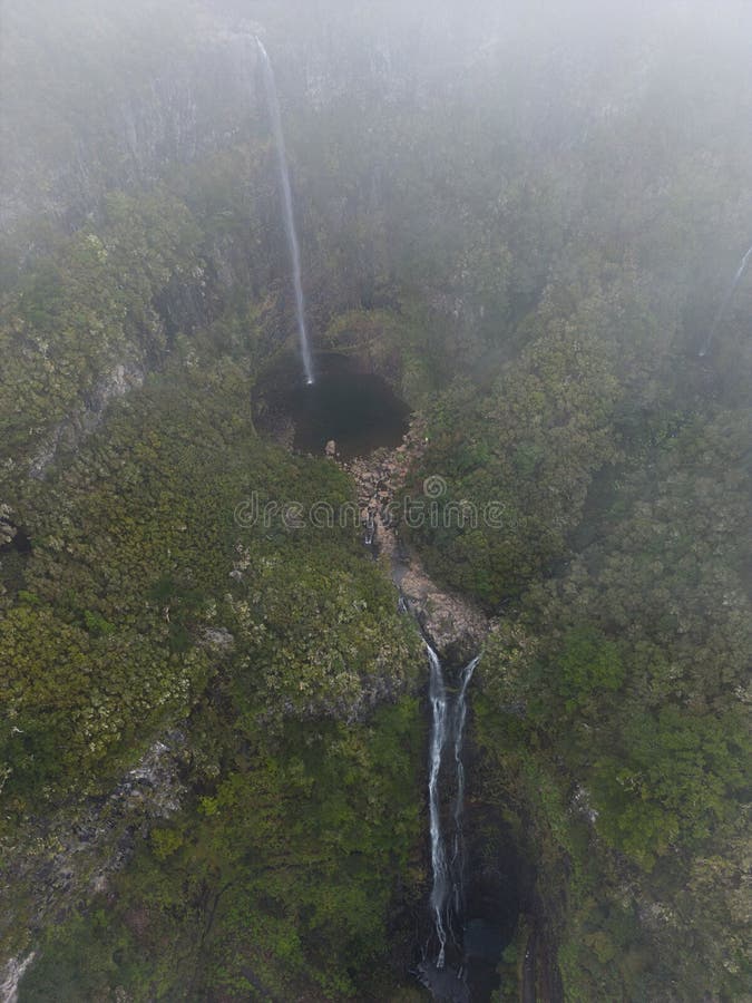 A Waterfall and Path in the Mist in Front of a Rainforest Stock Photo ...