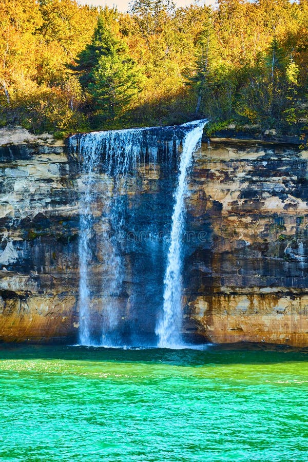 Waterfall at Pictured Rocks Cascading into Turquoise Waters in Lake ...