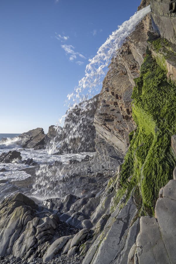 Waterfall Pouring Out of Cliffs at Sandymouth Bay Stock Image - Image ...