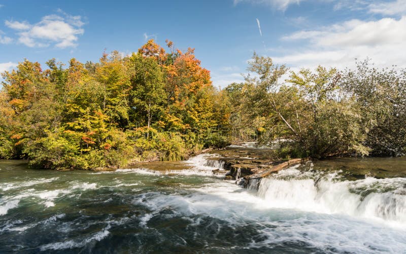 Waterfall and River with Trees in Fall Colors in the Background Stock ...