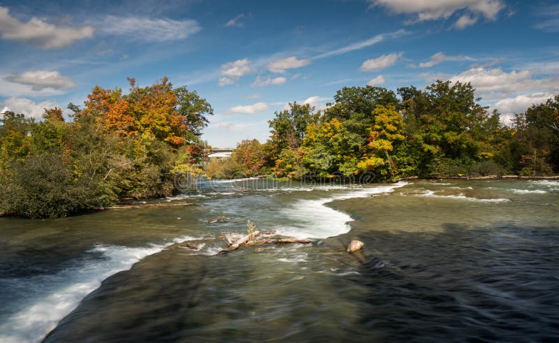 Waterfall and River with Trees in Fall Colors in the Background Stock ...