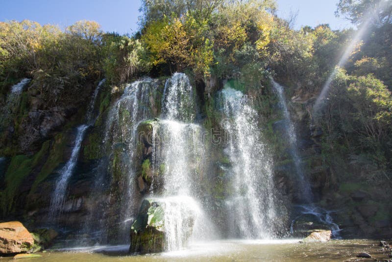 Waterfall between rocks stock image. Image of cascade - 195824925