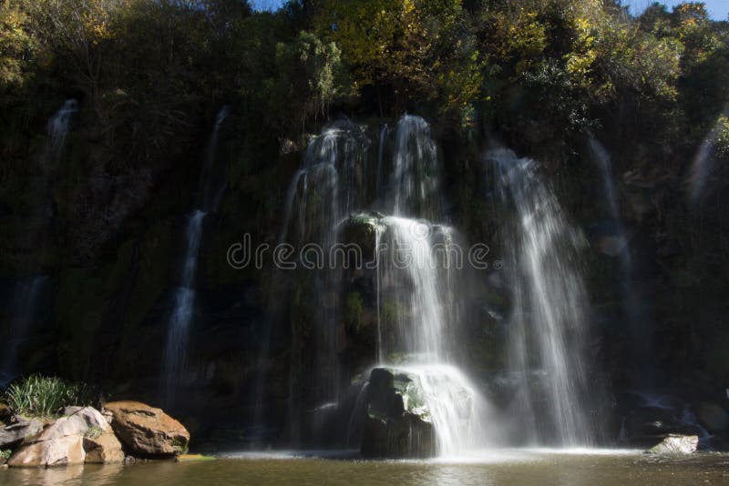Waterfall between rocks stock image. Image of trees - 195825095
