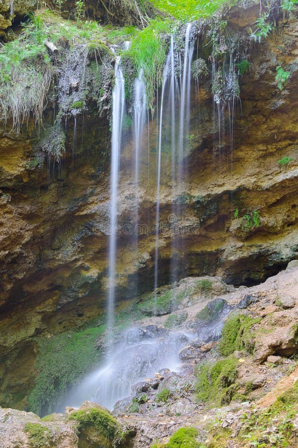 Waterfall on a rocky cliff stock photo. Image of leaf - 125079908