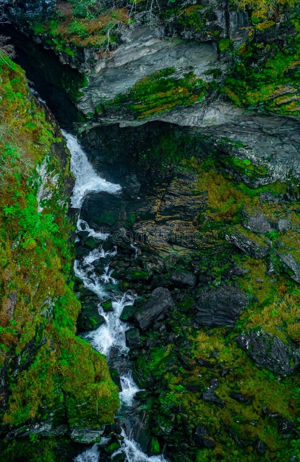 Waterfall in a deep ravine stock photo. Image of mountain - 200537100