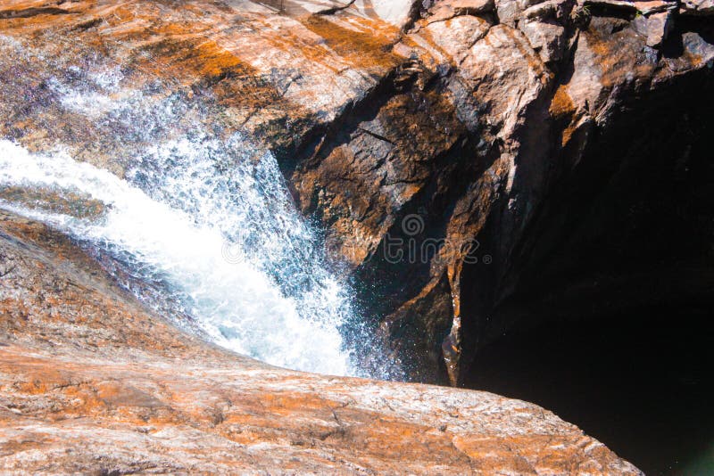 Waterfall Running Off the Surface of a Colourful Rock Stock Image ...