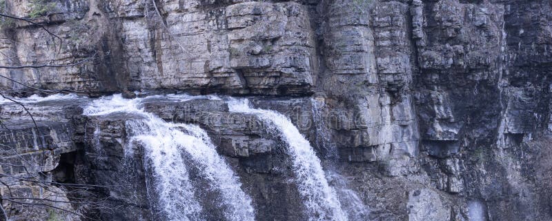 Waterfall Running into River in the Rocky Mountains Stock Photo - Image ...