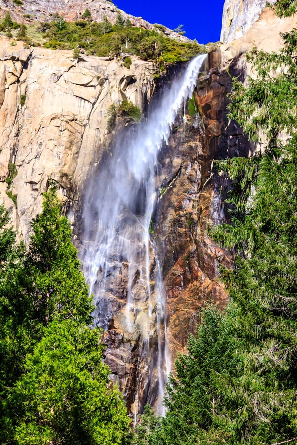 A Waterfall is Seen in the Distance with a Mountain in the Background ...