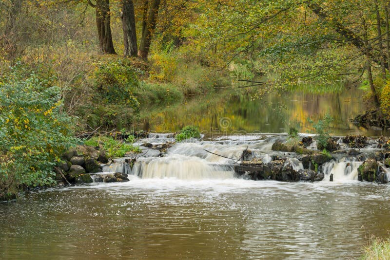 Waterfall on a Small River Flowing through the Autumn Forest. Stock ...