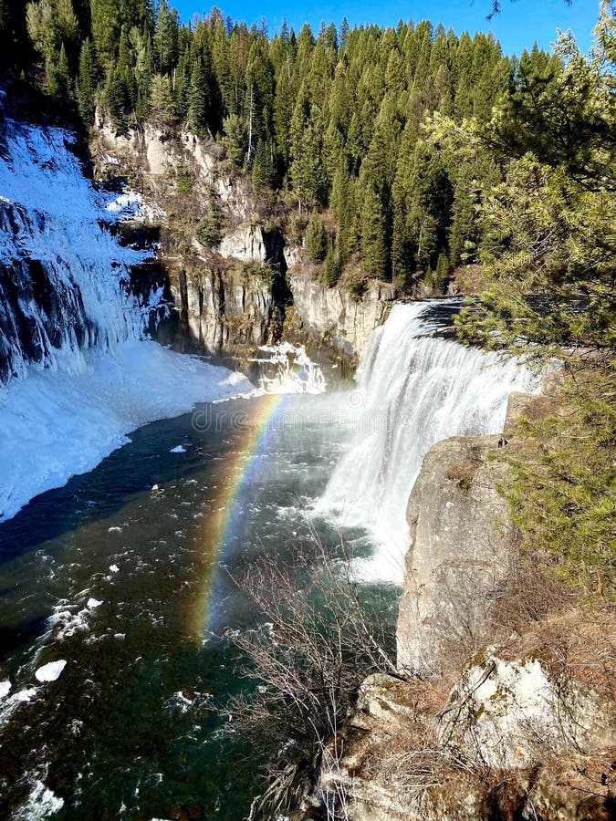 Waterfall with Snow and Rainbow in the Mist Stock Photo - Image of ...
