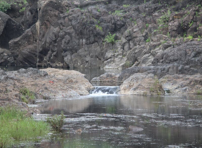 Waterfall between Some Rocks and Flowing Water Stock Image - Image of ...