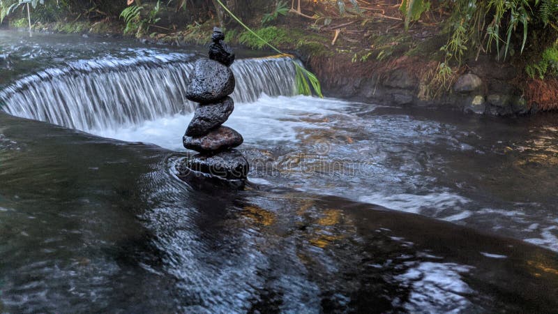 A Waterfall with a Stack of Cairn Stones Stock Photo - Image of nature ...
