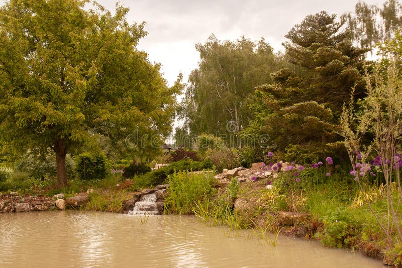 Waterfall steps into pond stock photo. Image of seat - 117899834